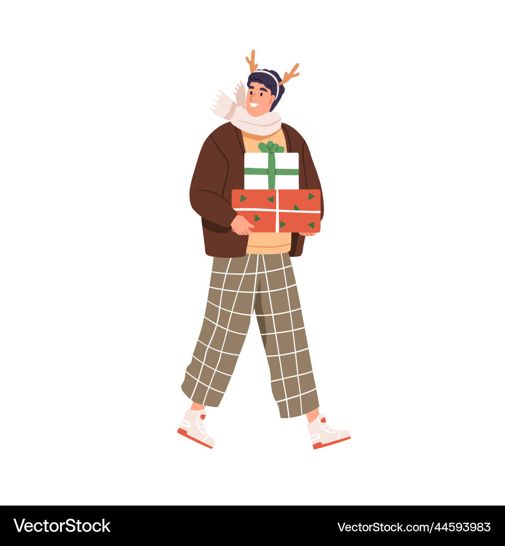 Happy man going with christmas gift boxes outdoors