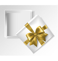 Black gift box with gold ribbon and bow - top view