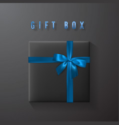 Black gift box with blue bow and ribbon top view Vector Image